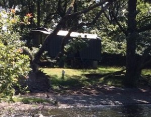 The green caravan opposite Peel Island and Coniston Water – Sophie Neville